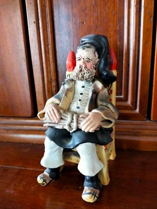 statuetta uomo seduto 