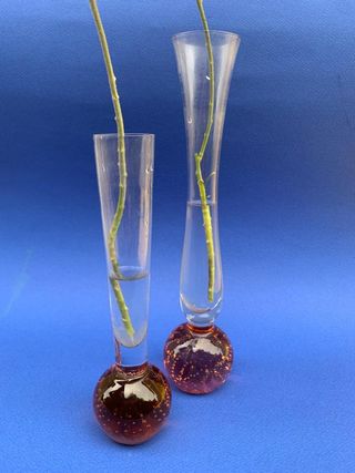 2 orange flower vases with bubble glass base