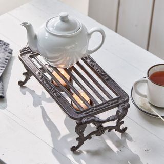 Scaldavivande a candele in ghisa