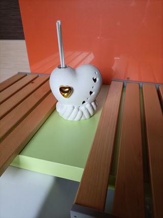 Profumatore a forma di cuore dentro le mani